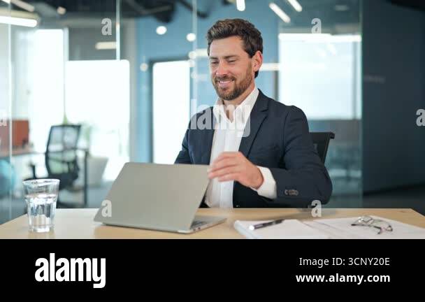 Successful businessman, dressed in a sharp suit, finishes his tasks in ...