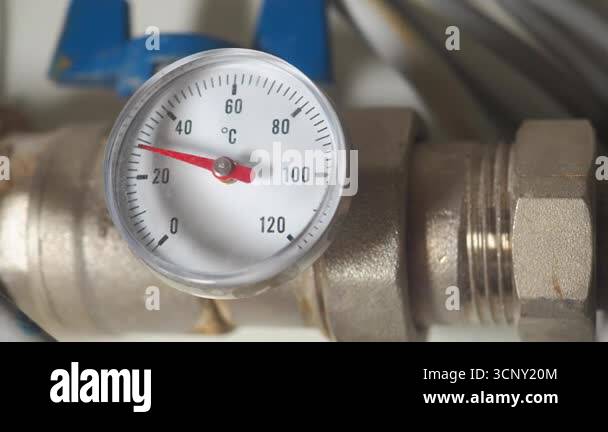 Close-up display of a temperature gauge measuring heat in a plumbing ...