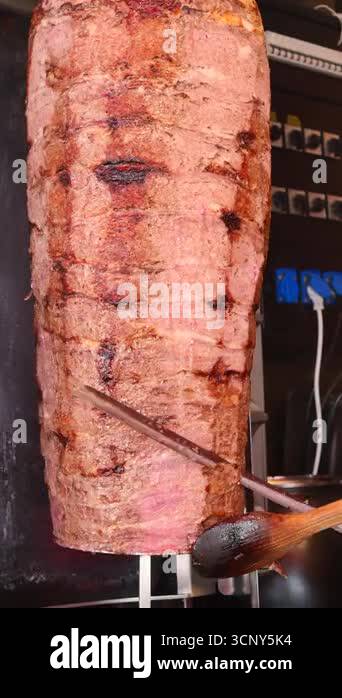 Chefs skillfully slice mouthwatering shawarma at a street stand Stock ...