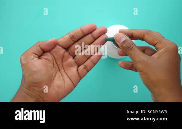 Demonstrating the proper technique to apply hand sanitizer effectively ...