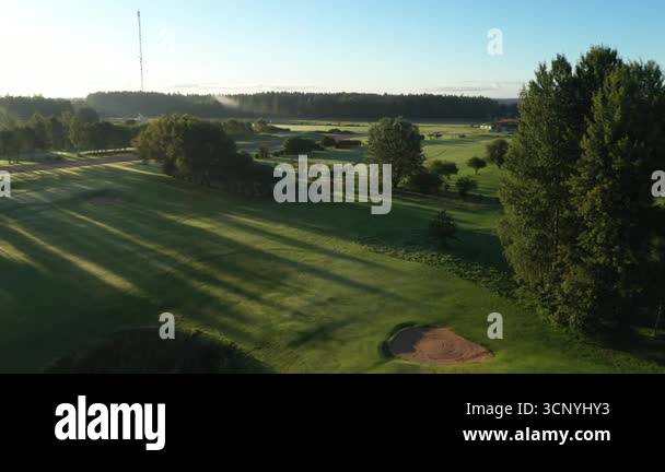 Drone view of Avoti Golf Course at sunrise with long shadows, fresh dew ...