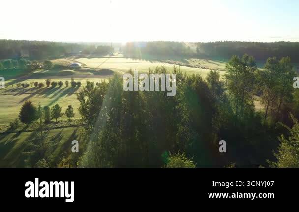 Morning sun rises over Avoti Golf Course, highlighting manicured greens ...
