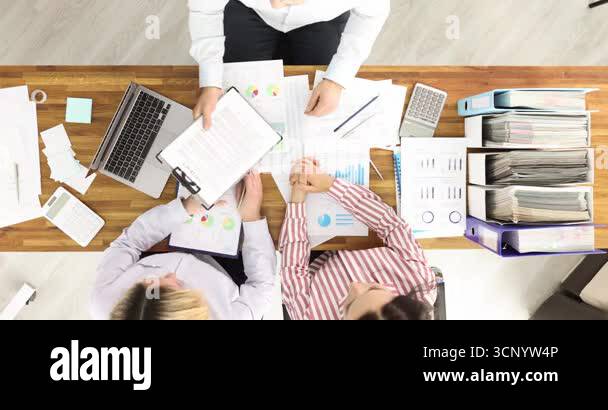 Businessman signs contract document and shakes hands with woman manager ...