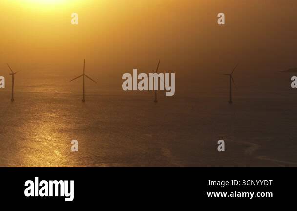 Aerial drone view of the golden sun over the Danish coast, casting ...