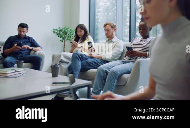 Camera slowly sliding in from of multi-ethnic group of people sitting ...