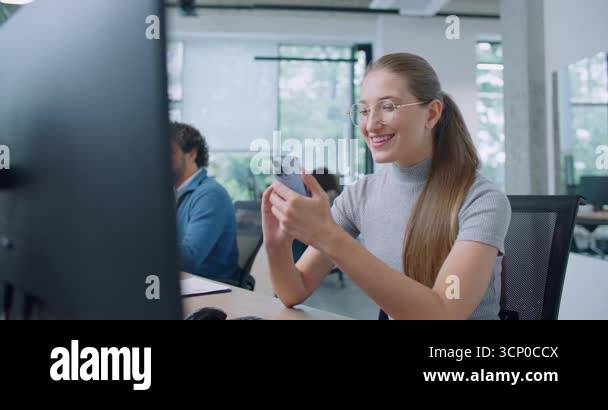 Pretty Caucasian woman with ponytail scrolling smartphone during her ...