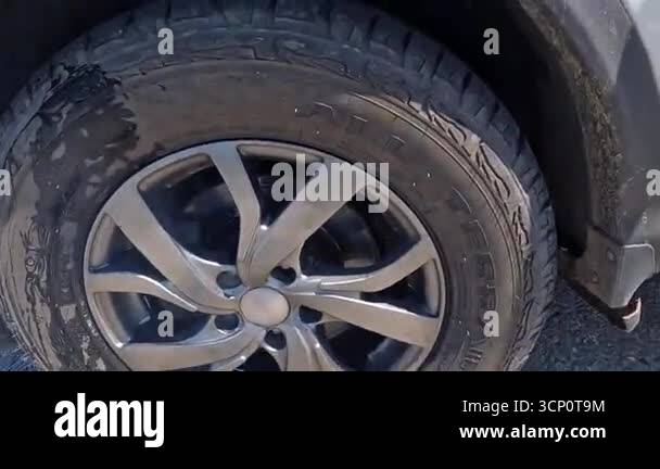 Close-up of the wheel brake pads caught on fire and are smoking. Water ...