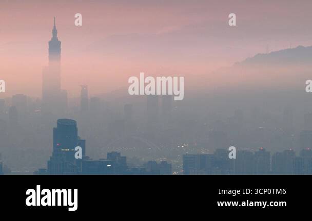 Taipei City skyline from Dadao Mountain at dawn. Orange mist envelops ...