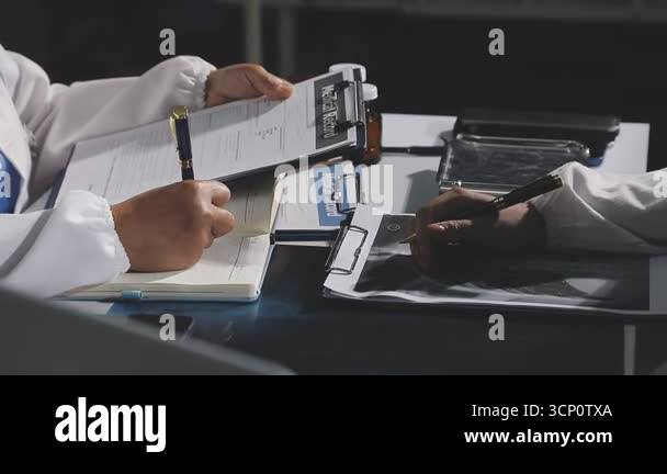 doctor writing notes on clipboard Stock Video Footage - Alamy