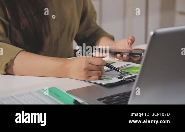 young business woman holding credit card using laptop computer and ...