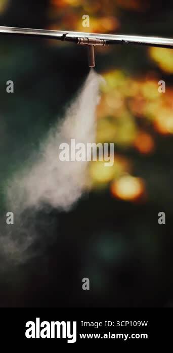 A jet of water spraying into the air against a dark background Stock ...
