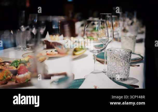 Refined restaurant table setting with crystal glasses, plates, and ...