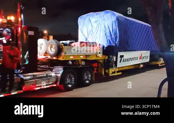 Bogot, Colombia - September 11, 2025 - A truck is loading a train car and heading towards Bosa ...