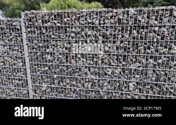 gabion fences filled with pebbles and quartz stones.lawn, street, wire ...