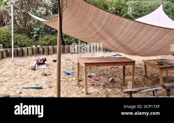 low palisade of logs in the sandbox delimiting the playing area on the ...