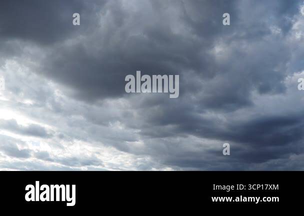 Dark clouds fill the sky, signaling an incoming storm in the late afternoon. The atmosphere is ...