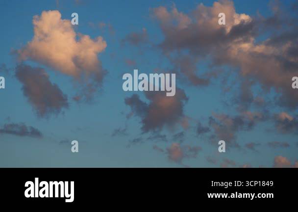 Witness the beauty of clouds moving across a clear sky at sunset ...