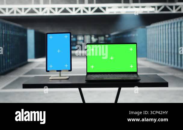 Isolated screen tablet and laptop in high tech data center facility ...