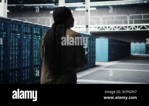 Data center technician using machine learning on tablet to optimize operations. IT specialist ...