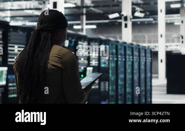 Data center software developer doing AI data analysis on tablet to ...