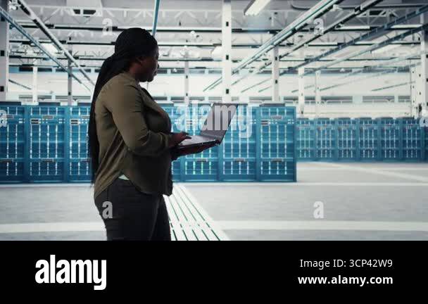 Smiling data center engineer pleased after minimizing downtime using ...