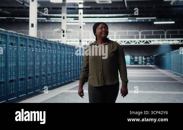 Engineer walking in data center, checking hardware for system stability ...