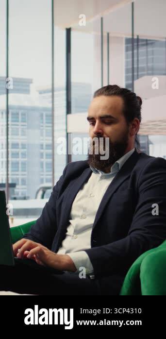 Vertical Video Entrepreneur in his luxurious office working on pc for ...