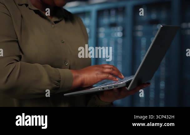 Close up of manager working in data center using laptop to optimize network infrastructure. IT ...