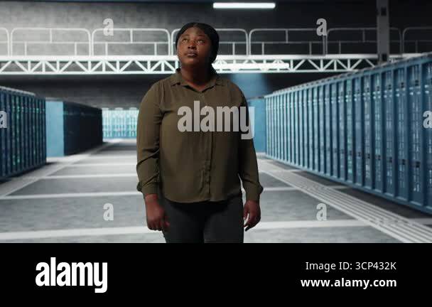 Engineer walking in data center, checking hardware for system stability ...