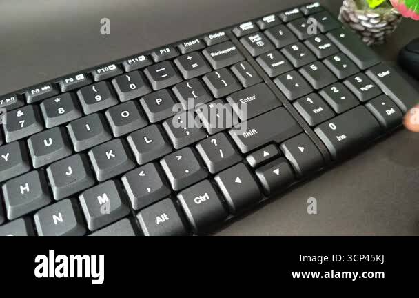 Footage of a finger pressing the Enter key on a modern black mechanical ...