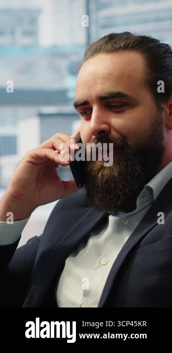Vertical Video CEO multitasking and managing an important phone call ...