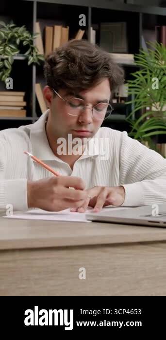 Young handsome guy participates from home in the office in an ...