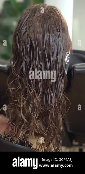 Beautiful curls of a girl in a beauty salon. The result of the work of ...