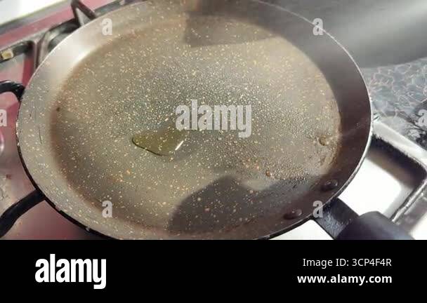 Sprinkle sunflower oil on the frying pan. High quality 4k footage Stock ...
