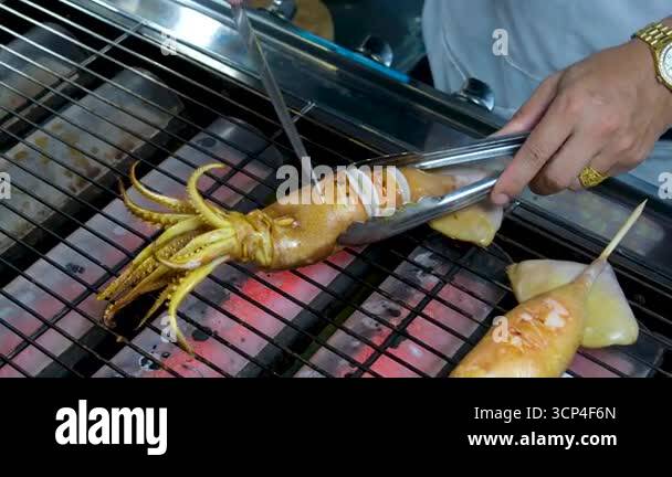 Fresh squid on a stick, Grilled Squid Tentacles on a Stick, Thai street ...