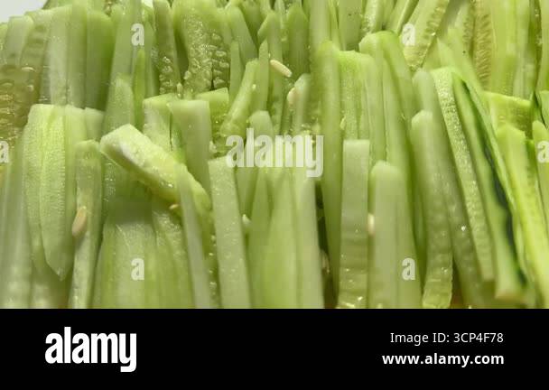 Cutting fresh cucumber into slices with special fruit and vegetable ...