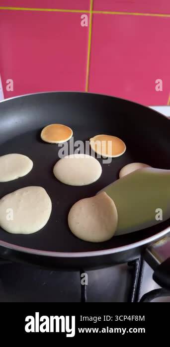 pancakes in a frying pan , metal pan while cooking pancakes with butter ...
