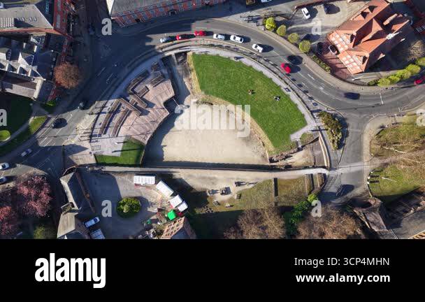 An aerial perspective showcases a circular park bordered by roads. A ...