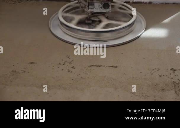 Rotating power trowel blades smooth liquid foam concrete and cement ...