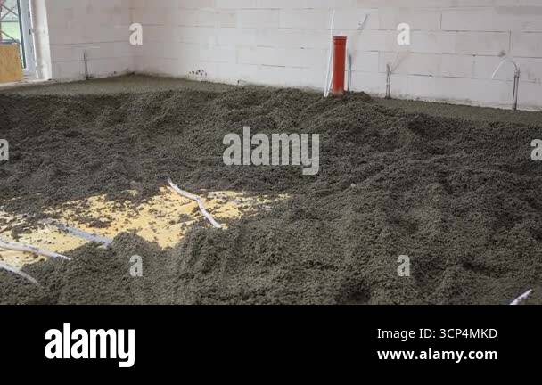 Interior of an unfinished building with liquid foam concrete and cement ...