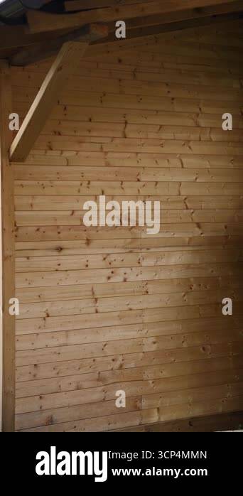 A wooden structure with a slanted roof and partially open doorway ...