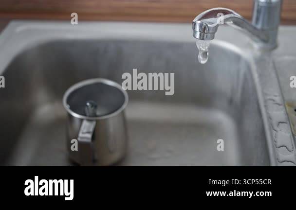 Stunning visuals of clear water beautifully flowing from a sleek tap ...