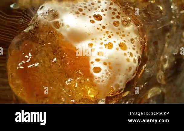 Super Slow Motion of Pouring Beer into Pint Glass, Top Down View ...