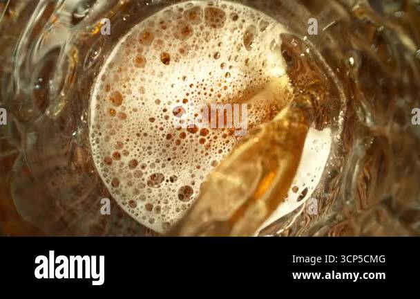 Super Slow Motion of Pouring Beer into Pint Glass, Top Down View ...