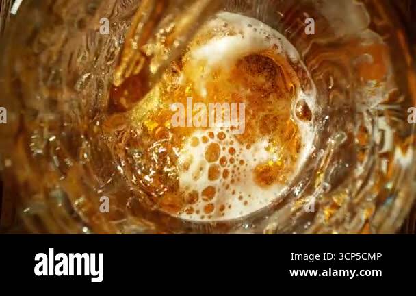 Super Slow Motion of Pouring Beer into Pint Glass, Top Down View ...