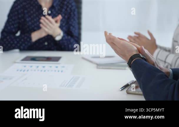 Business colleagues are applauding after successful presentation during ...