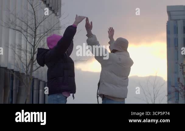 In this uplifting video, two young women joyfully stand together in ...