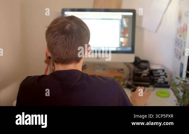 An individual is actively engaged in computer work, illustrating a ...