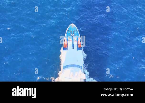 Bright sunlight glints off the waters surface as a majestic vessel ...