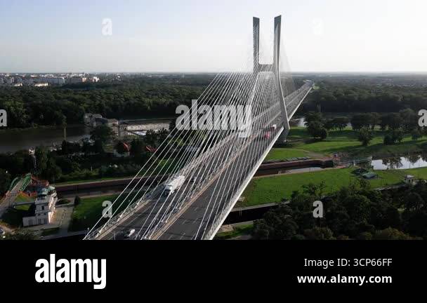 Aerial view of modern cable-stayed bridge over river with traffic and ...